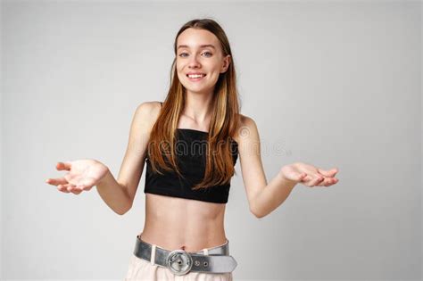 Young Woman In Black Crop Top And Cargo Pants With Hands Out Stock
