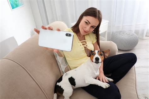Beautiful Woman Taking Selfie With Her Dog On Sofa Stock Image Image