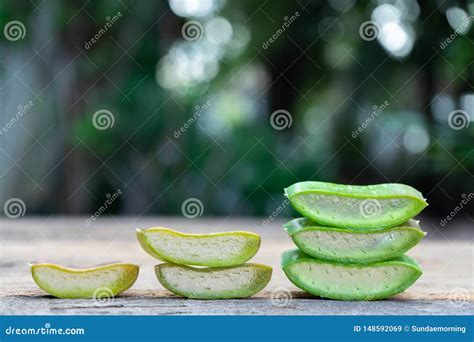 Fresh Aloe Vera Stem Slices And Gel On Wooden Table Skin Therapy