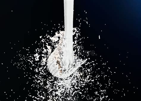 White Liquid Stream Falling Into A Puddle Of Water In The Middle Of A