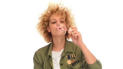 Premium Photo Young Female Model Blowing Soap Bubbles