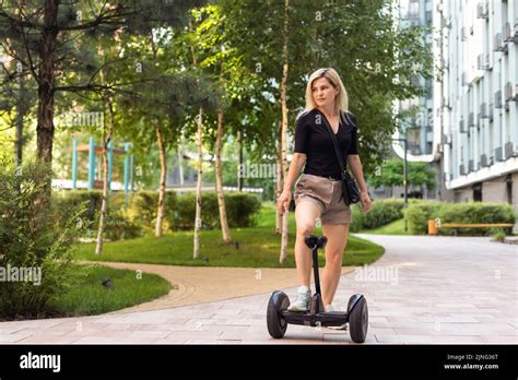 Beautiful Woman Stand Near Segway Or Hoverboard Self Balancing