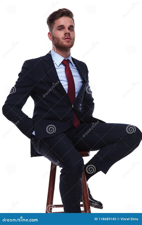 Portrait Of Proud Businessman Sitting On Wooden Stool Stock Image