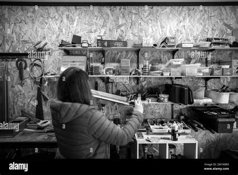 Female Working In A Tool Workshop Measuring Timber In Australia Stock