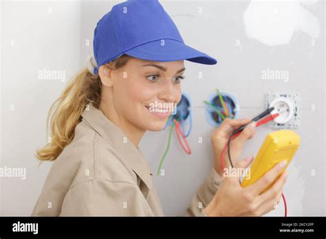 Portrait Of A Female Electrician Using Multimeter Stock Photo Alamy