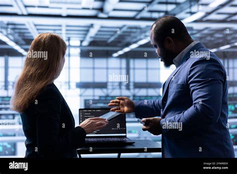 Admin And Manager Doing Disaster Recovery Planning And Security Protocol Enforcement In Data