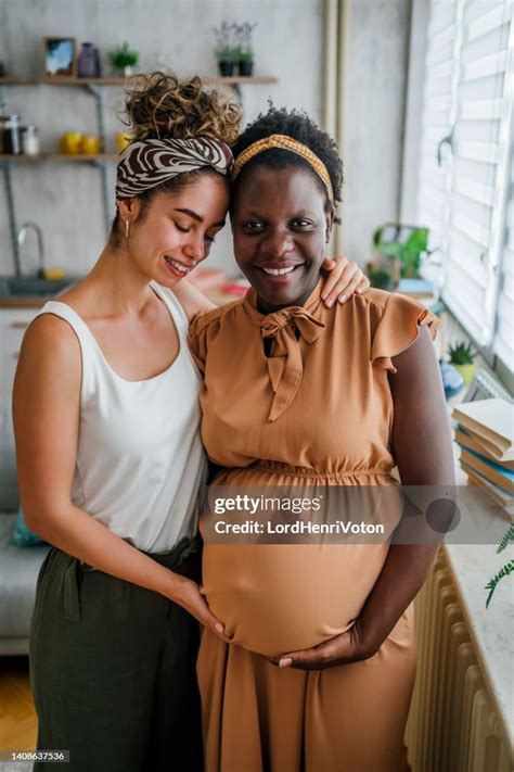 Pregnant Lesbian Couple Enjoying Time Together At Home High Res Stock