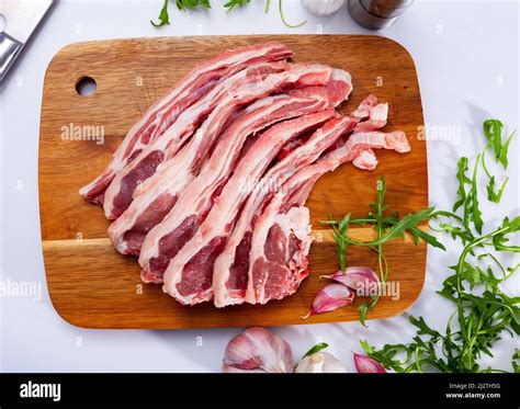 Raw Mutton Chops On Wooden Cutting Board With Herbs And Spices Stock