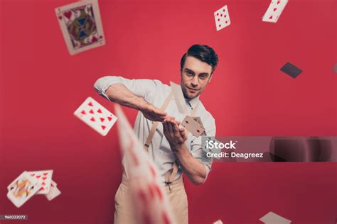 전문가 교활한 즐거운 마술사 마술 캐주얼 복장 안경 까다로운 눈 도박꾼 빨간색 배경 위에 서 있는 카메라를 던지고 보내는 카드 가능성에 대한 스톡 사진 및 기타 이미지