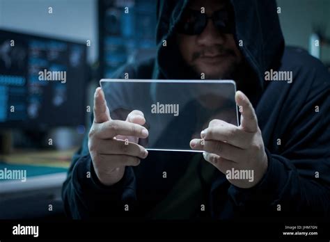 Hacker Using Blank Clear Glass Tablet With Blue Dark And Grain Process Concept For Cyber