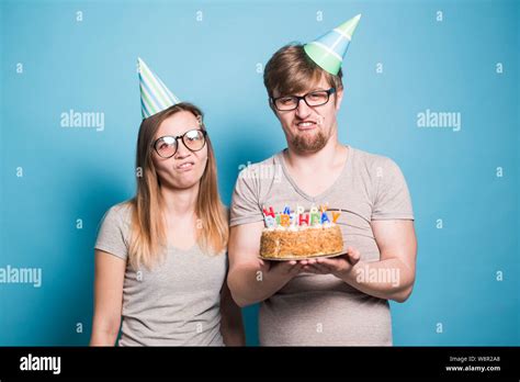 Cheerful Young Couple Charming Guy And Cute Girl In Paper Hats Make