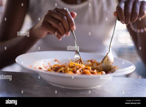 Young Beautiful African American Woman Enjoys While Eating Delicious