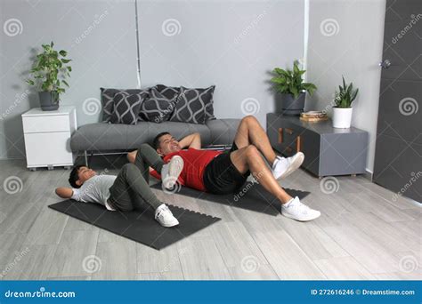 Overweight Latino Dad And Son Exercise At Home To Lose Weight And Be