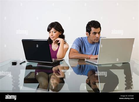 A Couple Using Laptops Stock Photo Alamy