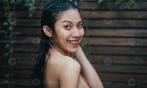 Beautiful Young Asian Woman Relaxing While Taking A Shower 6162384