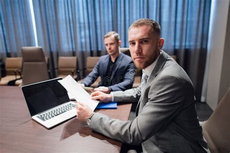 Female Worker Showing Papers To Her Serious Boss In The Meeting Room