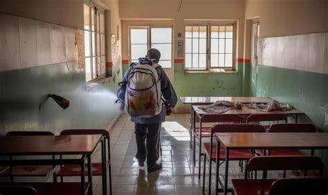 Premium Ai Image A Student Walks In A Classroom With A Backpack On