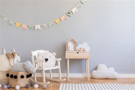스칸디나비아 아이 룸 회색 벽 천연 바구니 어린이의 자에 테 디 베어와 디자인 장난감 다채로운 면 깃발 및 액세서리와 함께 나무