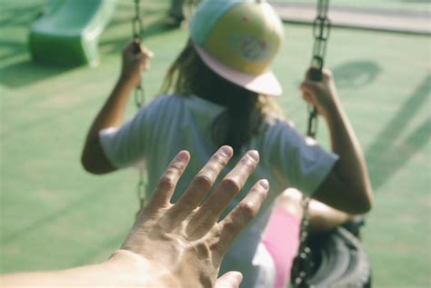 Premium Photo Cropped Hand By Girl Swinging At Park