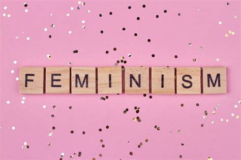 Feminism Word Written On Wooden Cubes Against Pink Background Stock