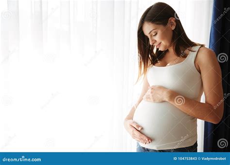 Portrait Of A Happy Pregnant Woman Touching Her Belly Stock Image