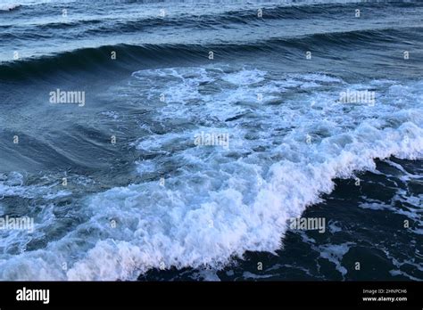 Detailed Close Up View On Water Surfaces With Waves And Ripples And The Sunlight Reflecting At