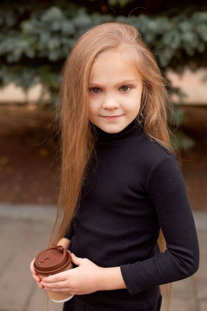 Premium Photo A Blonde Girl In A Black Sweatshirt Is Standing On The