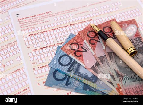 Australian Tax Form With Colorful Australian Dollar Banknotes Close Up