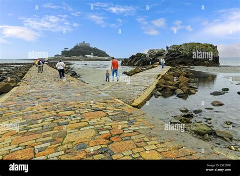 Tourists Walking On The Tidal Causeway To St Michael S Mount A Tidal