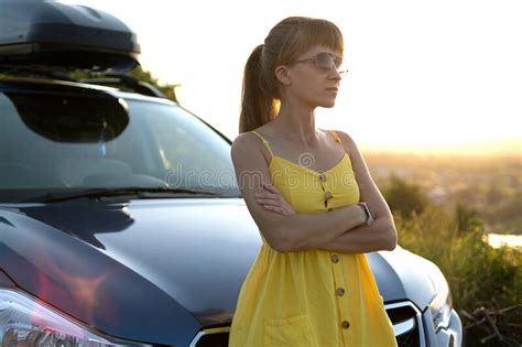 Happy Young Woman Driver In Yellow Dress Enjoying Warm Summer Evening