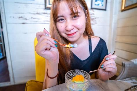 Premium Photo Cute Asian Women Eating Thai Desserts She Likes To Eat