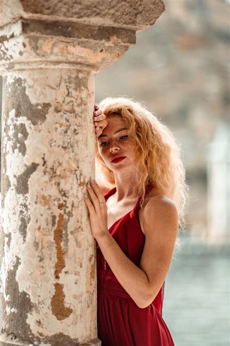 Outdoor Portrait Of A Young Beautiful Natural Redhead Girl With