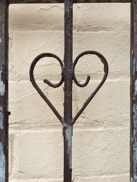 Close Up Of Wrought Iron Heart Shape Against Brick Wall Stock Image