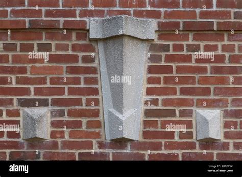 Decorative Molded Concrete Architectural Detail Appliqued On A Red Brick Wall Triangular Art