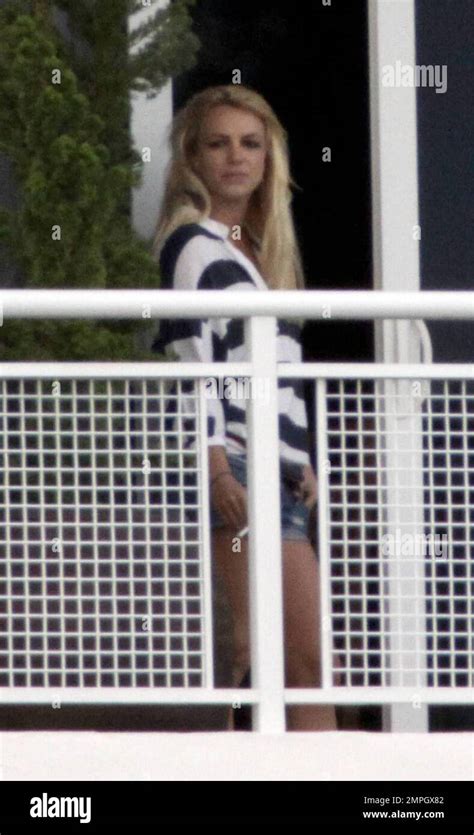 Britney Spears Wearing Daisy Dukes And A Striped Top Relaxes While Smoking A Cigarette On The