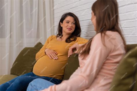 Premium Photo Two Pregnant Friends Talking Indoor They Share
