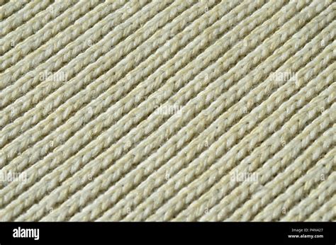 fabric texture of a soft yellow knitted sweater macro image of the