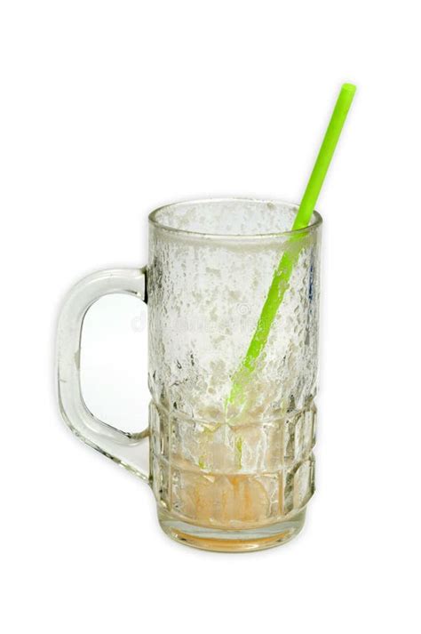 Empty Juice Glass Surrounded By Used Kitchen Wares After A Meal At A