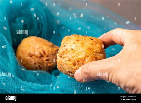 A Male Hand Taking A Tasty Baked Scone On A Blue Textile Background