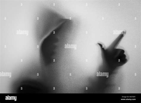 Shadow Blur Of Horror Man In Jacket With Hoodone Hands On The Glass