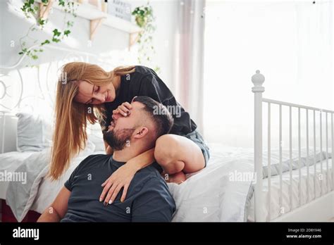Young Married Couple Have Leisure Together In Bedroom At Daytime Stock