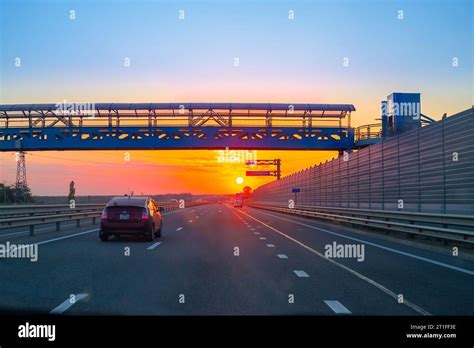 A Road With An Elevated Pedestrian Crossing A Noise Reducing Screen