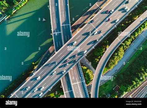 Aerial Of Vehicles Navigate A Complex Highway System Showcasing Overpasses And Intersections