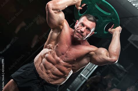 Male Bodybuilder Working Out With Weight Middle Aged Fitness Model