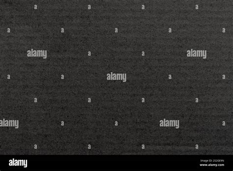 Textured Dark Surface Displays Gentle Patterns Under Soft Lighting In