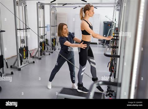 Woman Doing Exercise On Decompression Simulators With Trainer