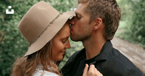 검은 양복을 입은 남자가 흰색과 갈색 격자 무늬 드레스 셔츠에 여자에게 키스 사진 Unsplash의 무료 시애틀 이미지