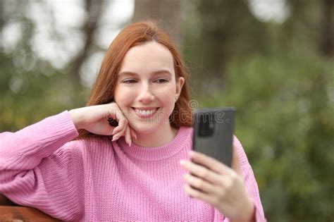 Beautiful Woman Smiles While Making Video Call With Her New Smartphone