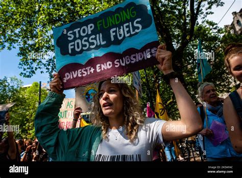 A Woman Is Holding A Placard Against Fossil Fuels During The Demonstration Organized By XR