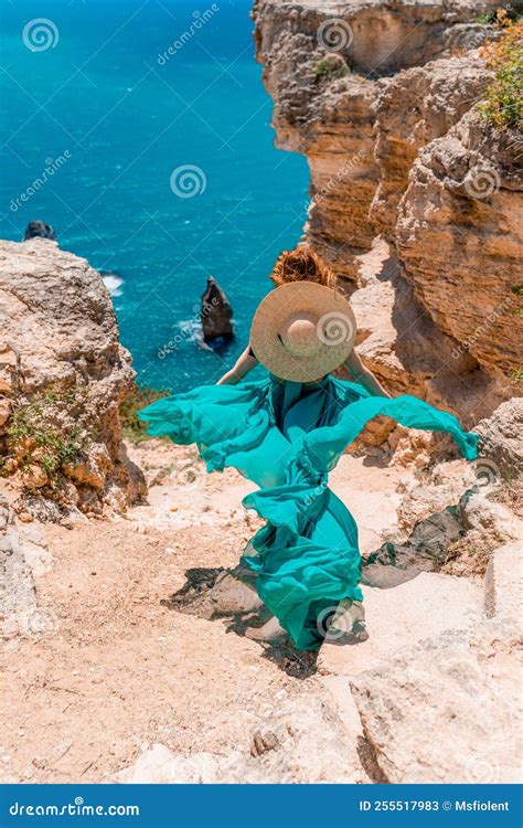 A Girl With Loose Hair In A Long Mint Dress Descends The Stairs Between